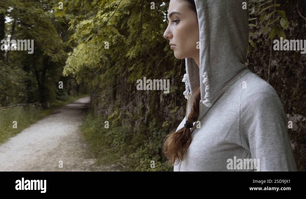 Sad woman lost in the woods looking around Stock Video Footage - Alamy
