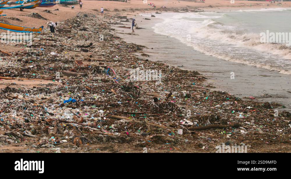Sea waves full of litter hitting the beach. Huge dump in tropical ...