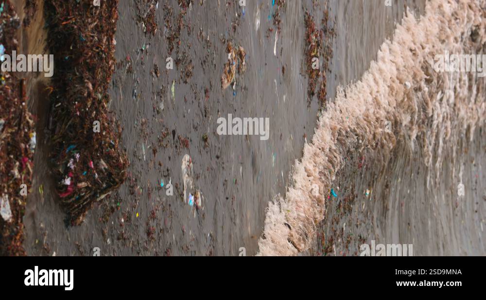 Sea waves full of litter hitting the beach. Huge dump in tropical ...