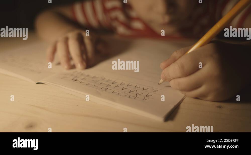 Boy using pencil and practising handwriting Stock Video Footage - Alamy