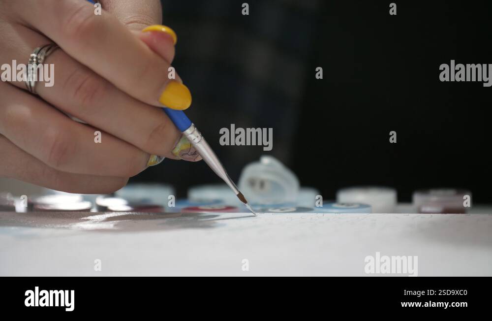 Spiritual girl with a yellow and blue makeup creating a picture on a ...
