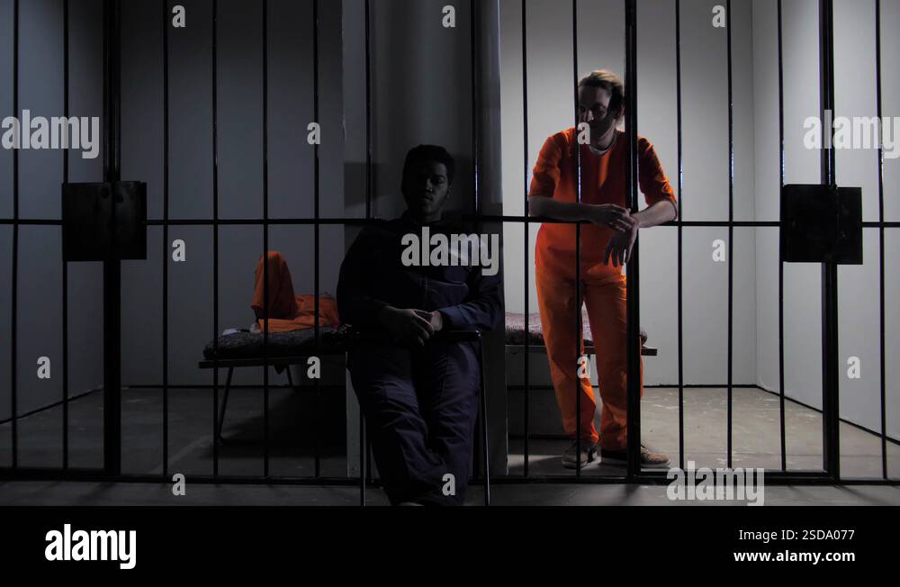 Prisoner speaks with security guard through bars Stock Video Footage ...