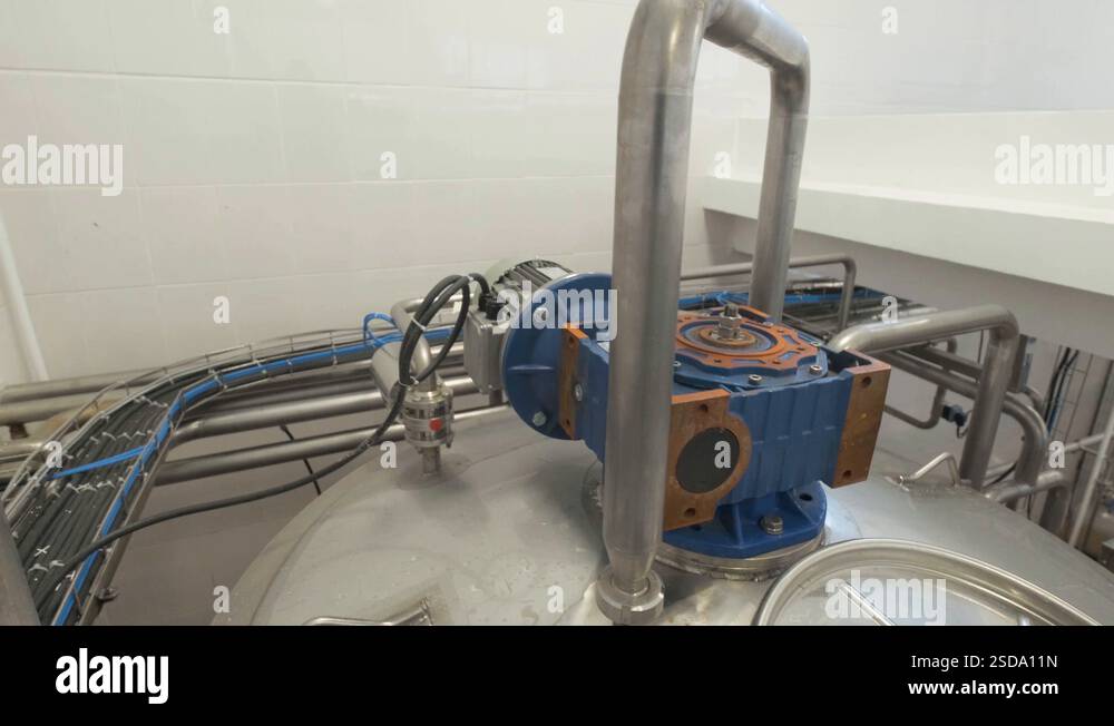 Plant.A large metal flask from which pipes and wires come out. Working ...