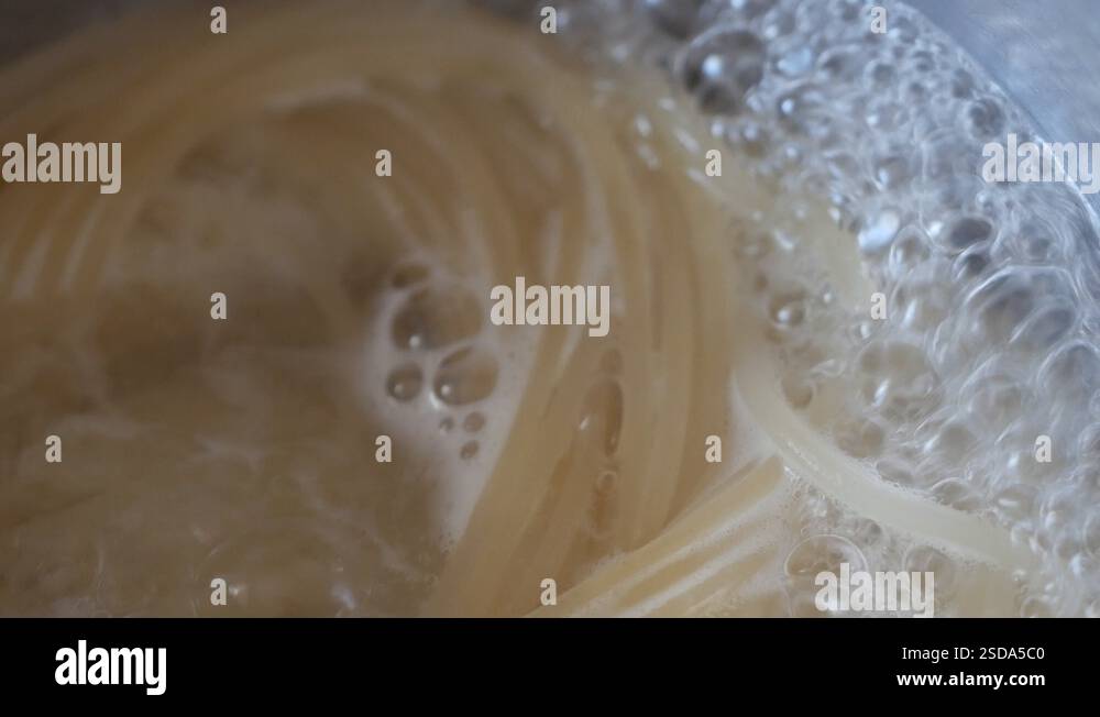 Spaghetti pasta in a metallic pan with boiling water. Cooking pasta ...