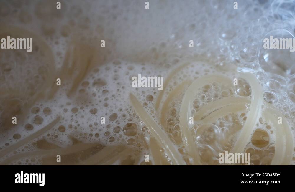 Spaghetti pasta in a metallic pan with boiling water. Cooking pasta ...