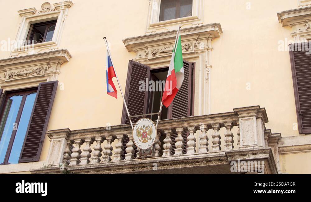 Italian and Russian flags wave in wind on building of Russian Center of ...