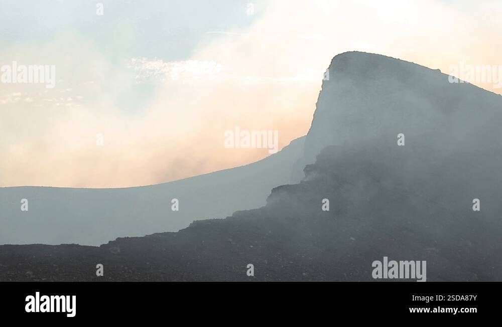 Camera pan shows the rim of a sulfur smoking volcano crater. Conception ...