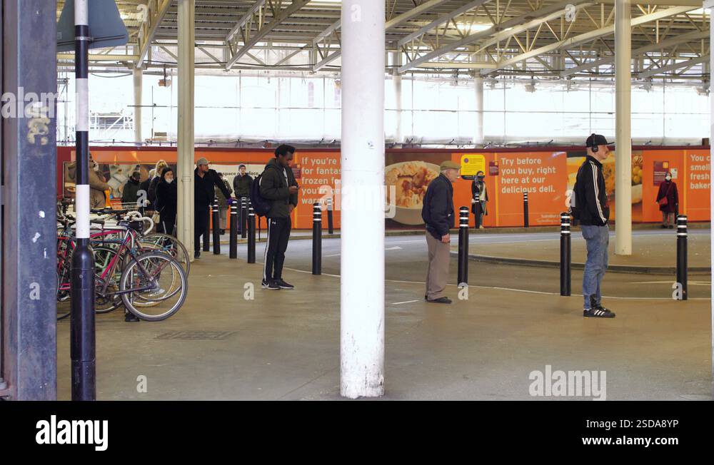 People maintain social distance of six feet while waiting to enter store Stock Video Footage - Alamy