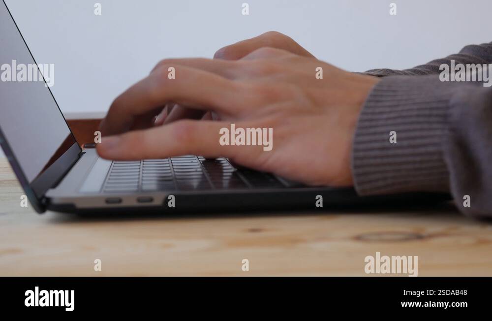Male use trackpad and type on the keyboard of laptop, personal computer ...