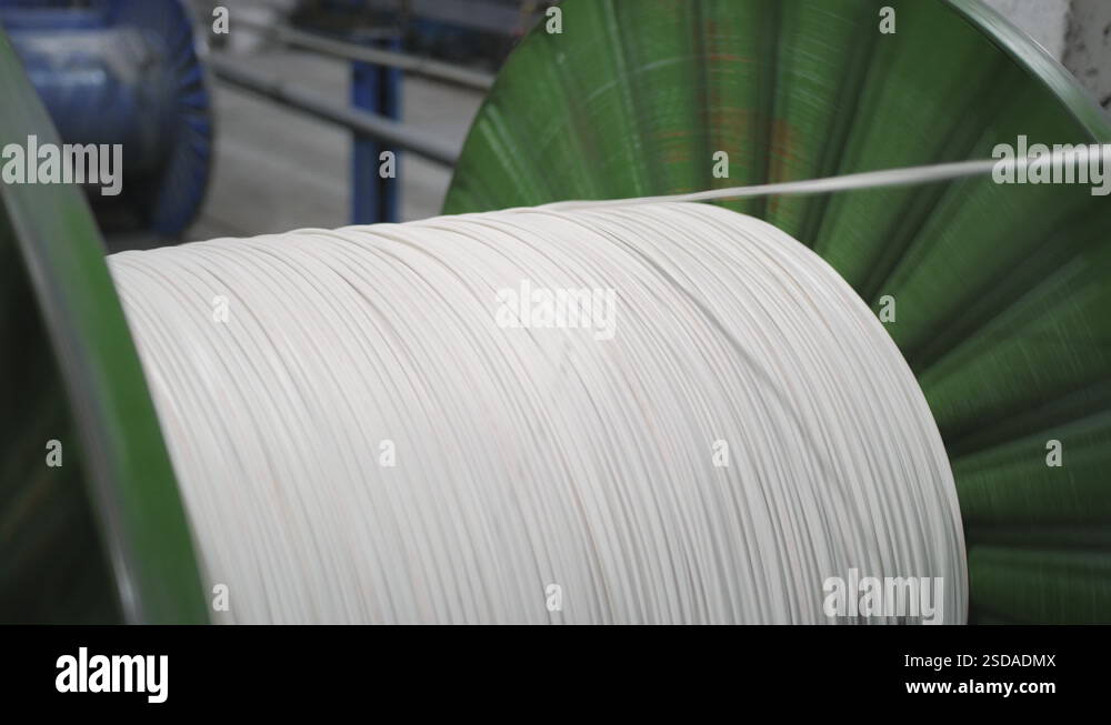 The copper winding of the cable on the reel. Production of electric ...
