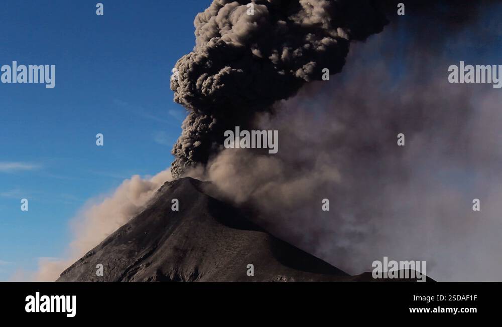 Fuego volcano, near Antigua, Guatemala, erupts heavily on a sunny day ...