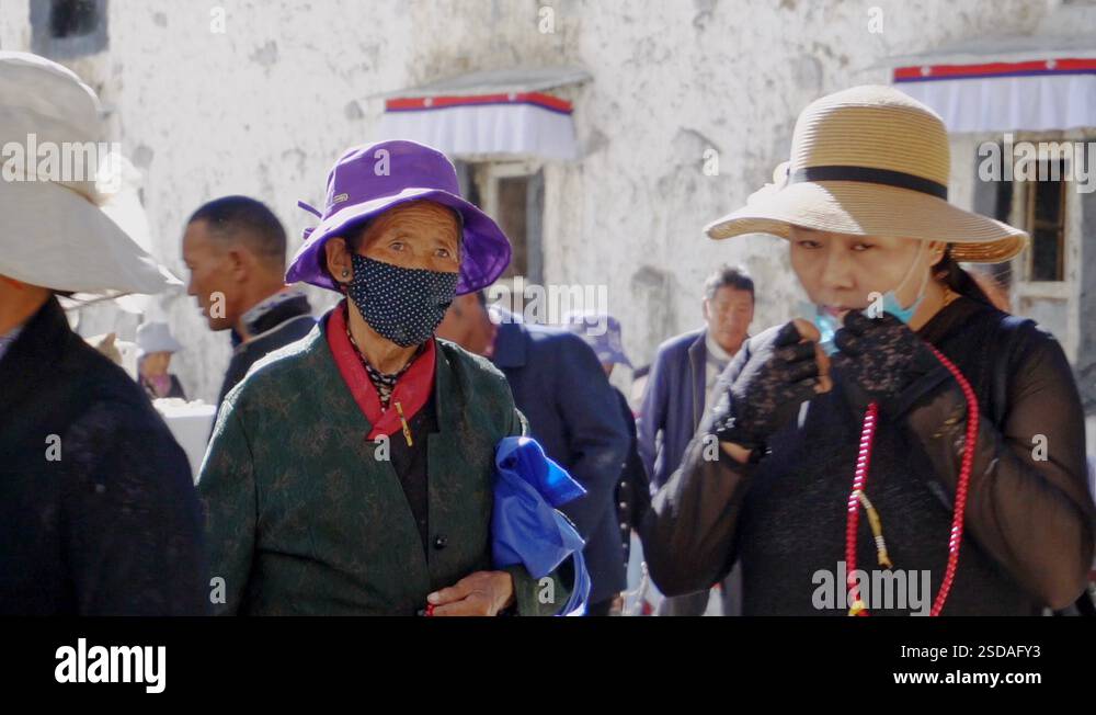 Tibetan and Chinese people on the streets, covering their faces with ...