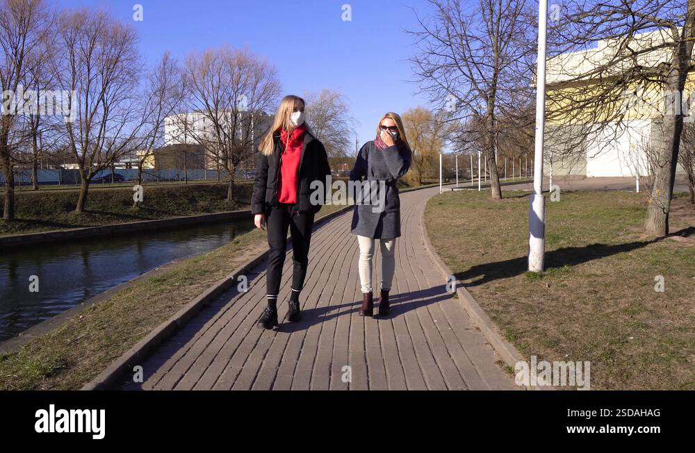 Two best friends girls had a walk on the river spring during isolation ...