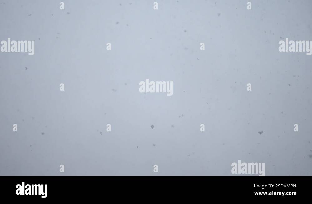 outside the window, snow is falling and it is snowing.big snow flakes ...