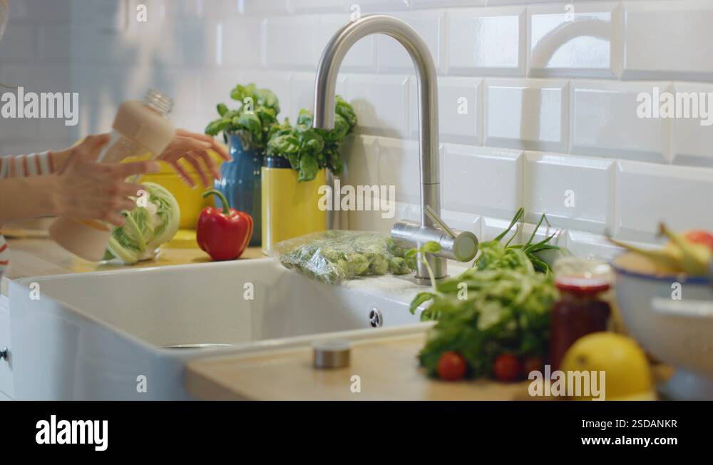 Close Up Footage of a Woman Filling a Reusable Plastic Bottle with ...