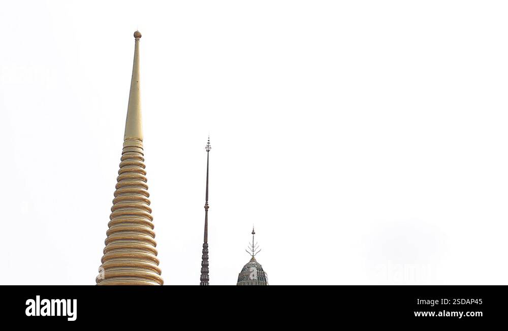 Tilting down shot of the beautiful spires of the Wat Phra Kaew temple ...