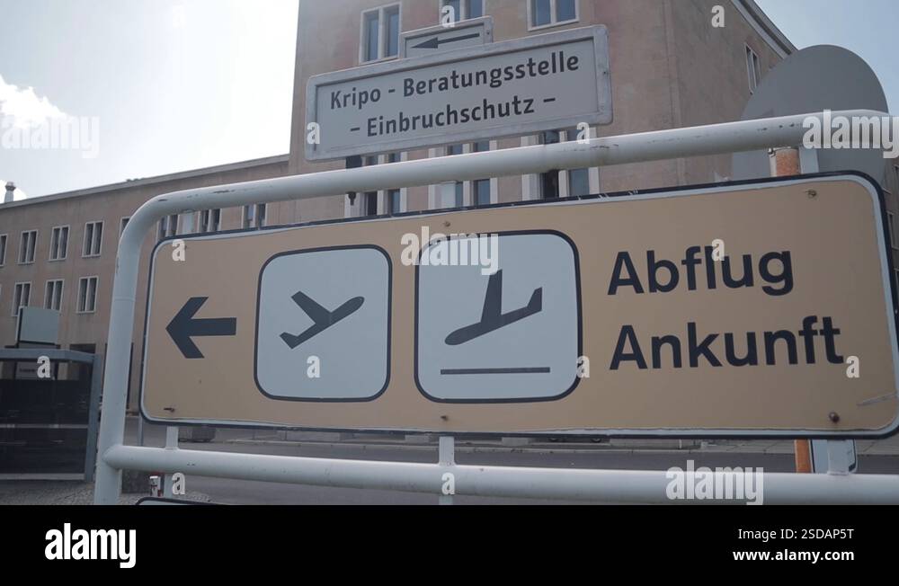 Slow pan on German Berlin city airport sign "Abflug & Ankunft" during ...