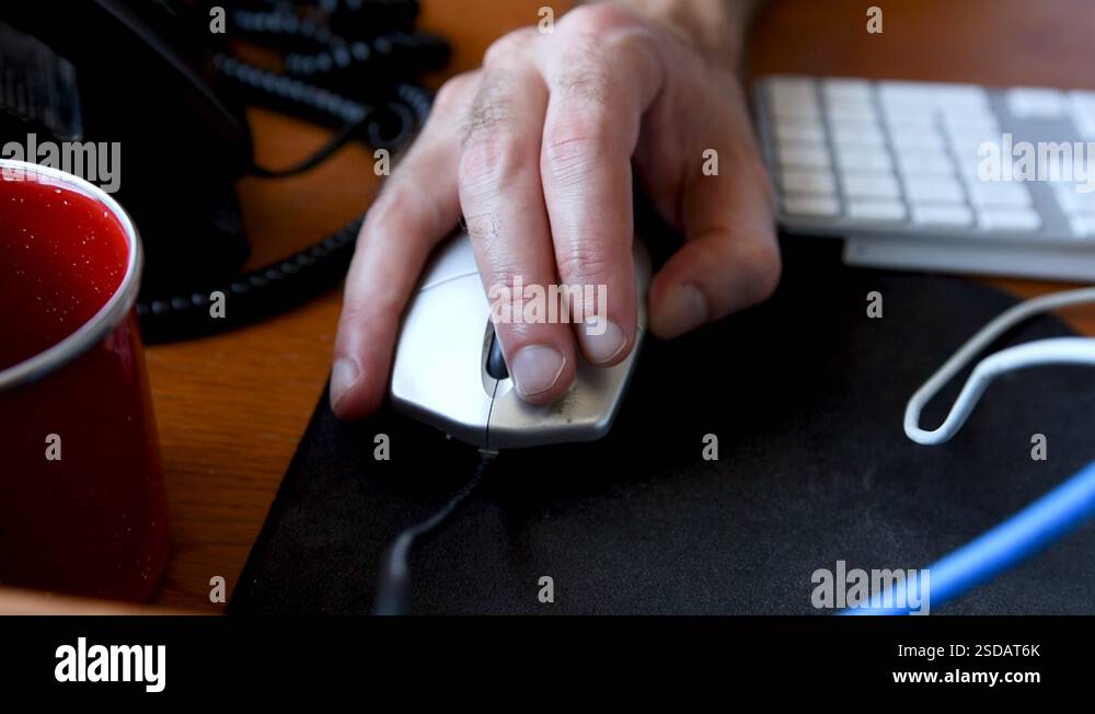 A man moving his computer mouse on a mouse pad on his desk Stock Video ...