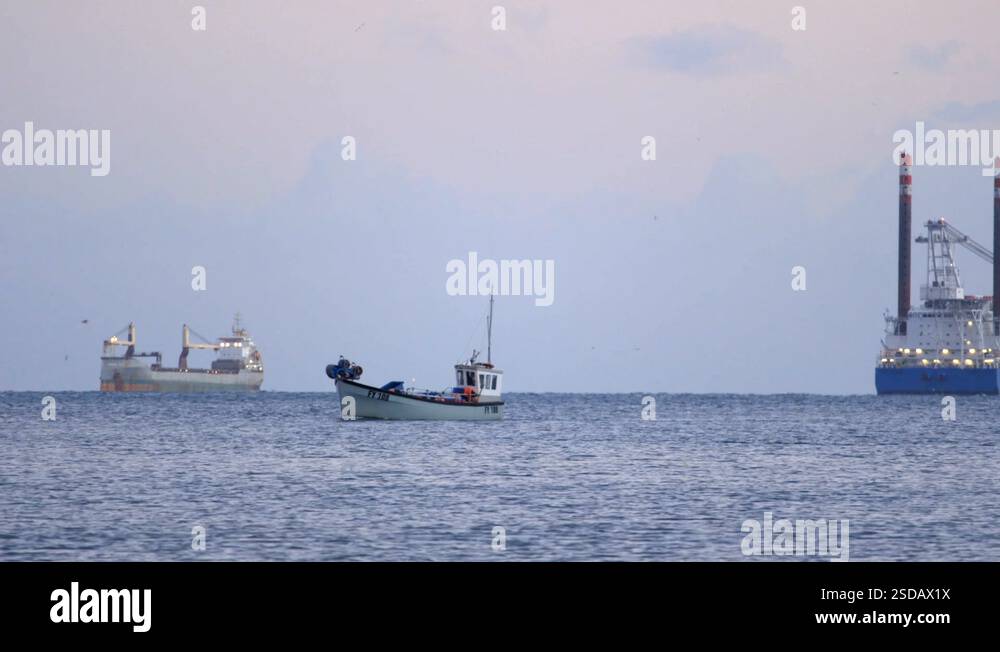 Fishing Boat. Freight Ships, and Birds Flying at Dusk or Dawn Off The ...