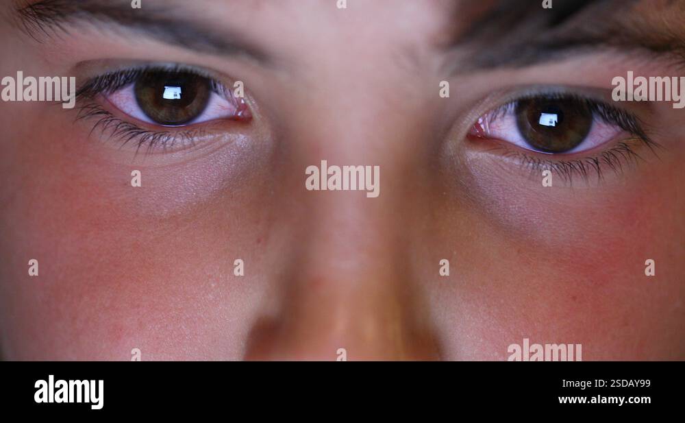Kid macro eyes staring at screen device at night. Child boy playing ...