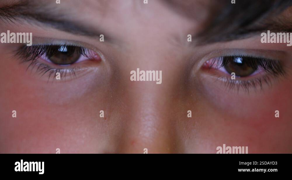 Kid eyes staring at screen light at night. Boy addicted to electronic ...