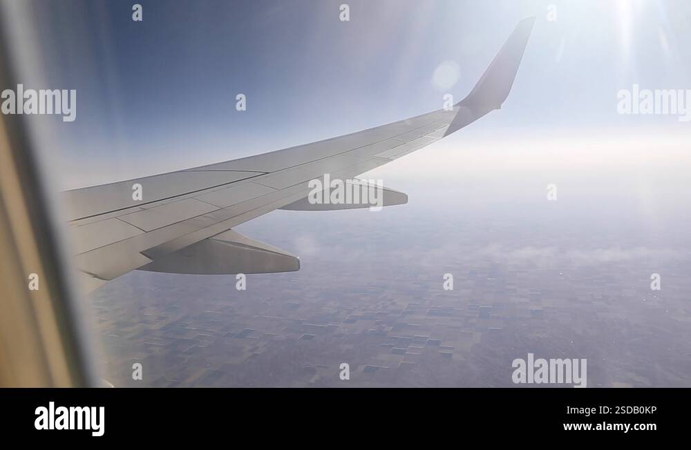 View from a commercial Delta airline window seat containing a wing of ...