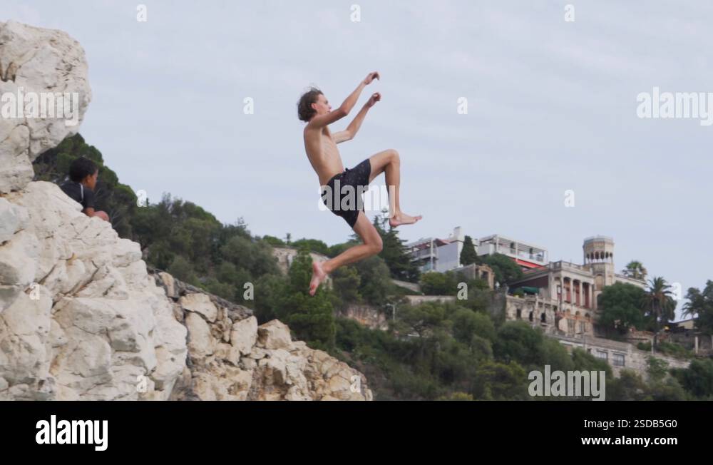 Male jumping of 4m cliff into ocean in slowmo. Modells name is Anton ...