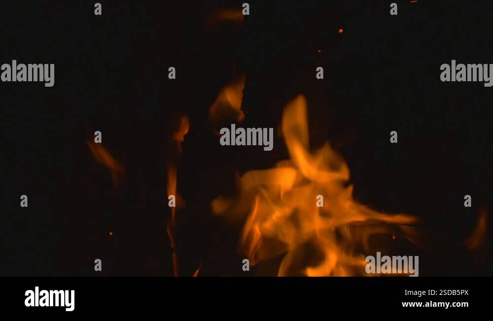 Slow motion of a Bonfire lit at night during the cold winter months to ...