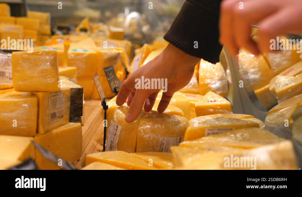 Close up hand of male consumer taking cheese from fridge with dairy ...