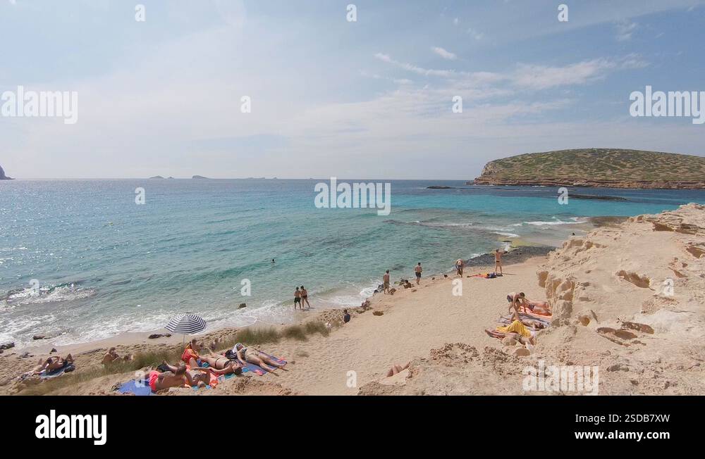 People sun tanning and enjoying their free day at the beach in Cala ...
