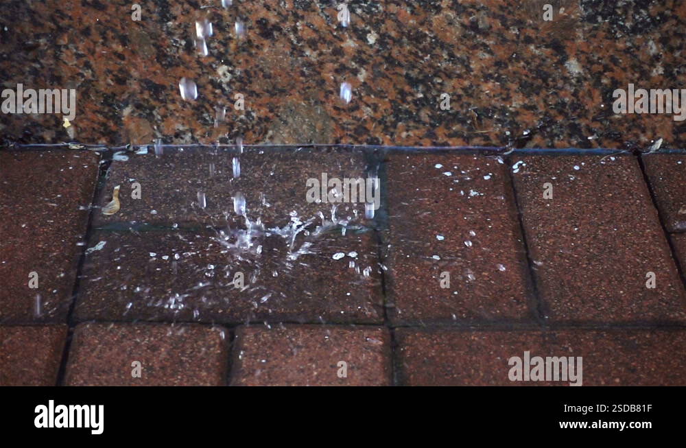 Raindrops falling in slow motion on a paving slab Stock Video Footage ...