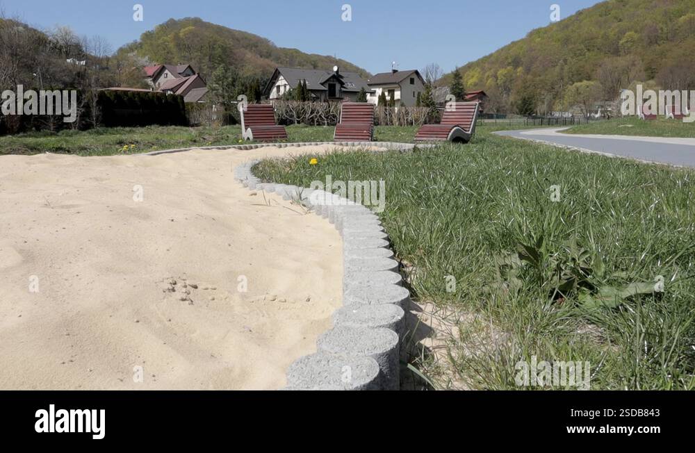 Man walking along a public sandbox has eventually sat and rested on a ...