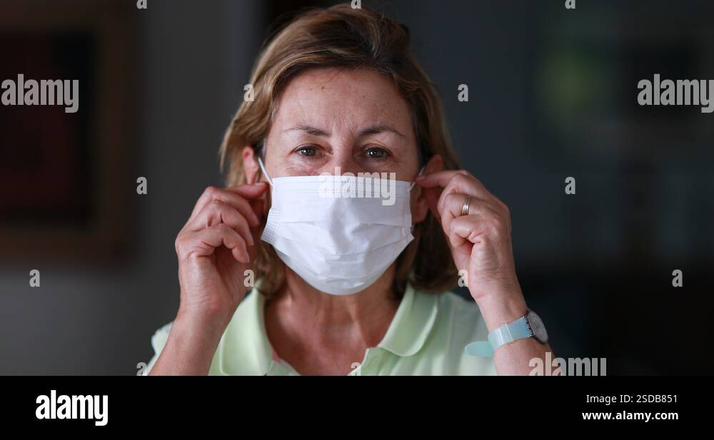 Portrait happy older woman removing surgical mask after ilness. Senior ...