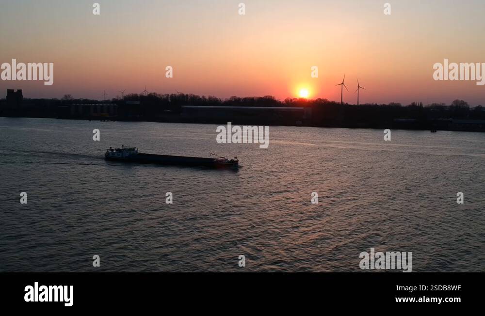 Drone time lapse of boat passing on river at golden hour sunset with ...