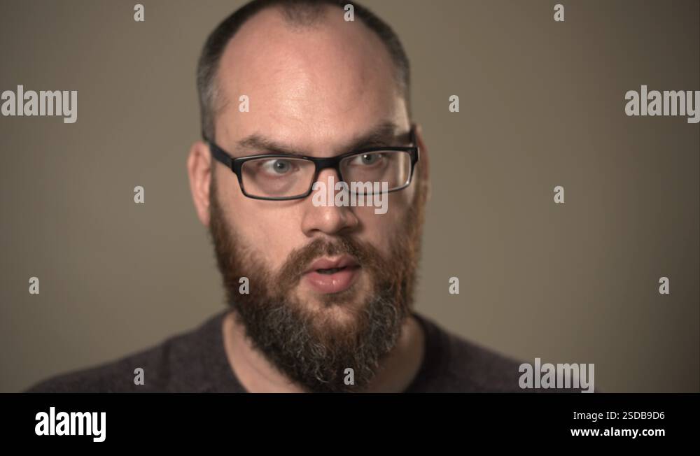 Man with beard trying to decide a difficult choice, or confused by a ...
