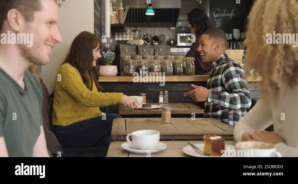 Two Couples Talking And Laughing At Tables In Cafe Stock Video Footage ...