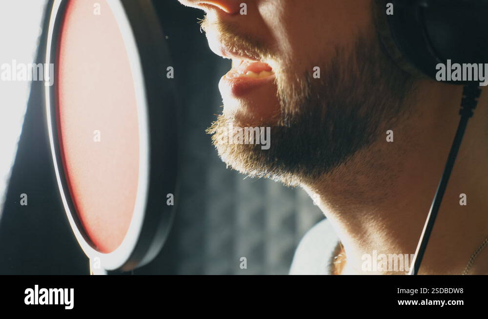 Mouth of male singer singing in sound studio. Unrecognizable man ...