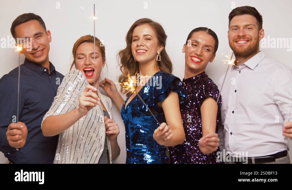 happy friends with sparklers dancing at party Stock Video Footage - Alamy