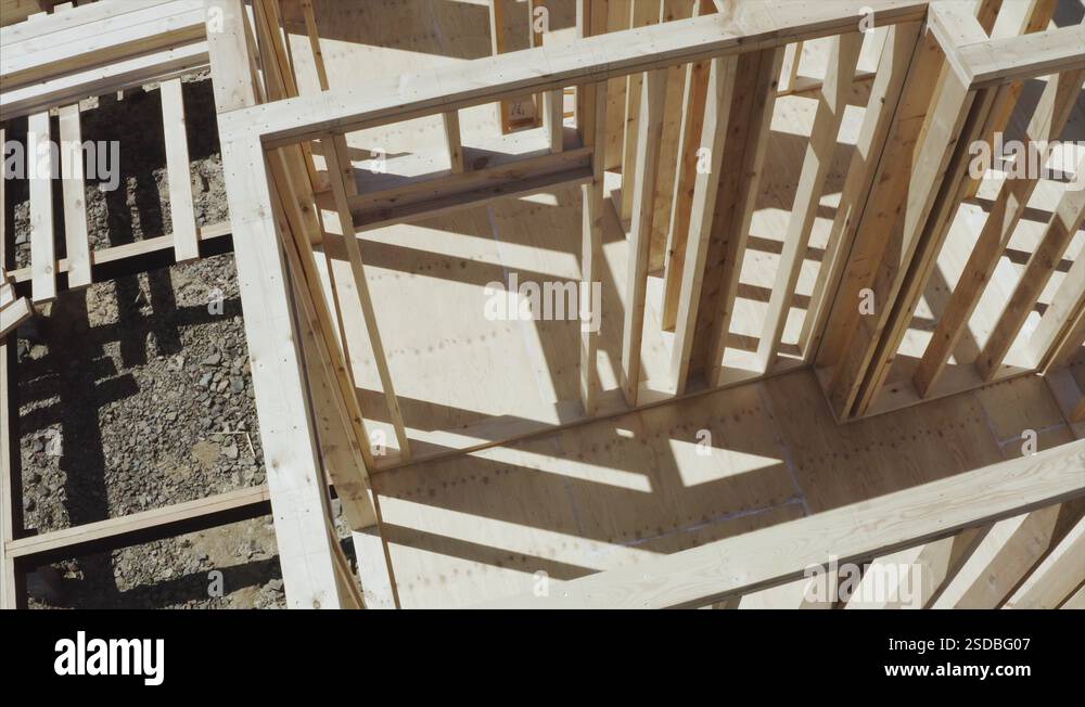 Flying low above walls of the wooden frame house under construction ...