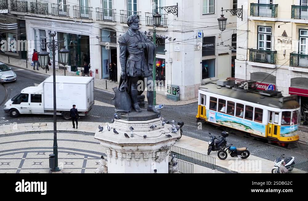 Statue of Portuguese poet Luis de Camoes and yellow tram at Plaza ...