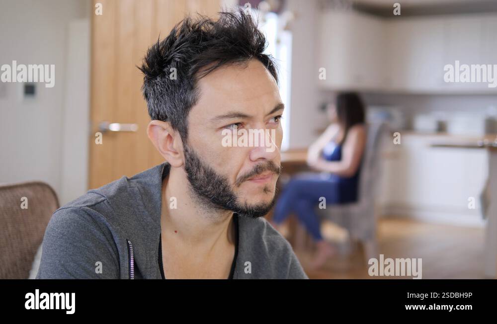 4K: Couple not speaking with one another. Rack focus shot from one to ...