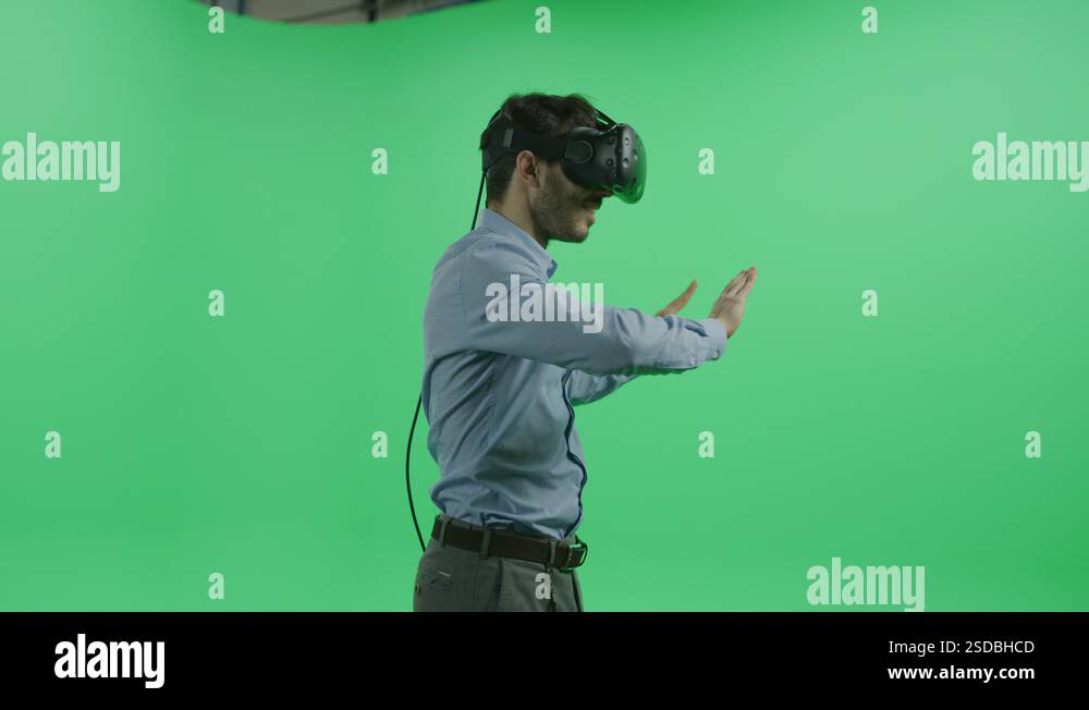 Green Screen Chroma Key Studio: Man Using Virtual Reality Headset for ...