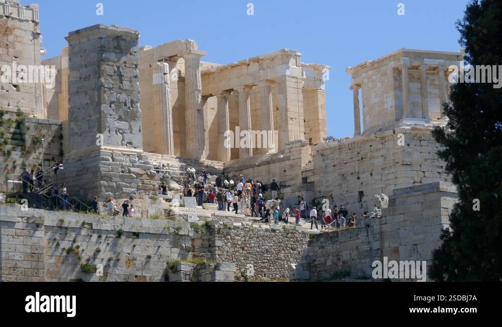 Long shot tourist visiting ruins of Athena temple inside acropolis of ...