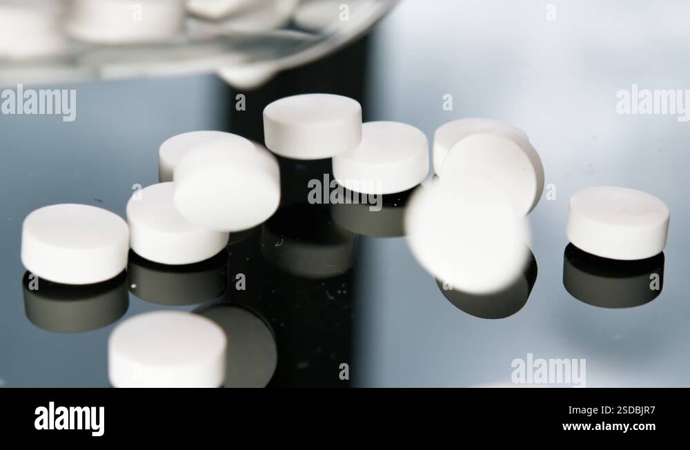 Spill heap of painkiller or antidepressant tablets on mirror surface ...