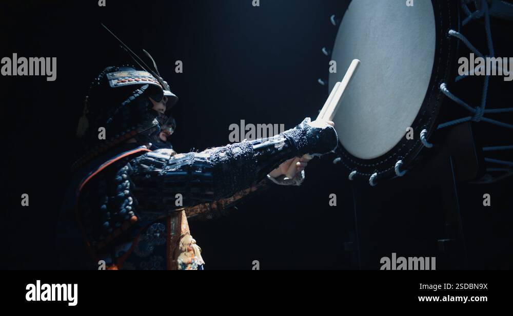 Japanese man in historical samurai costume playing on taiko drum with ...