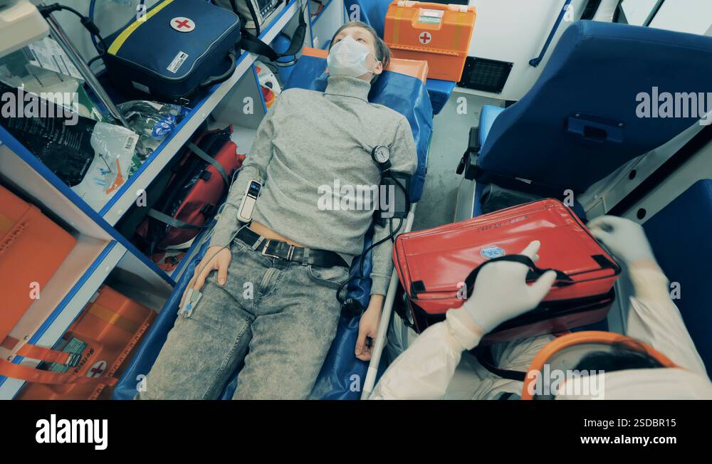 A doctor in a hazmat suit and a patient in the ambulance Stock Video ...