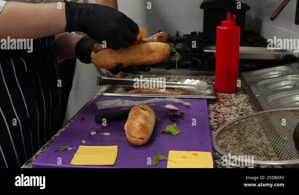 Cooking hot dog. Bun, cheese, ketchup. Decor plate. Dish from Chef ...