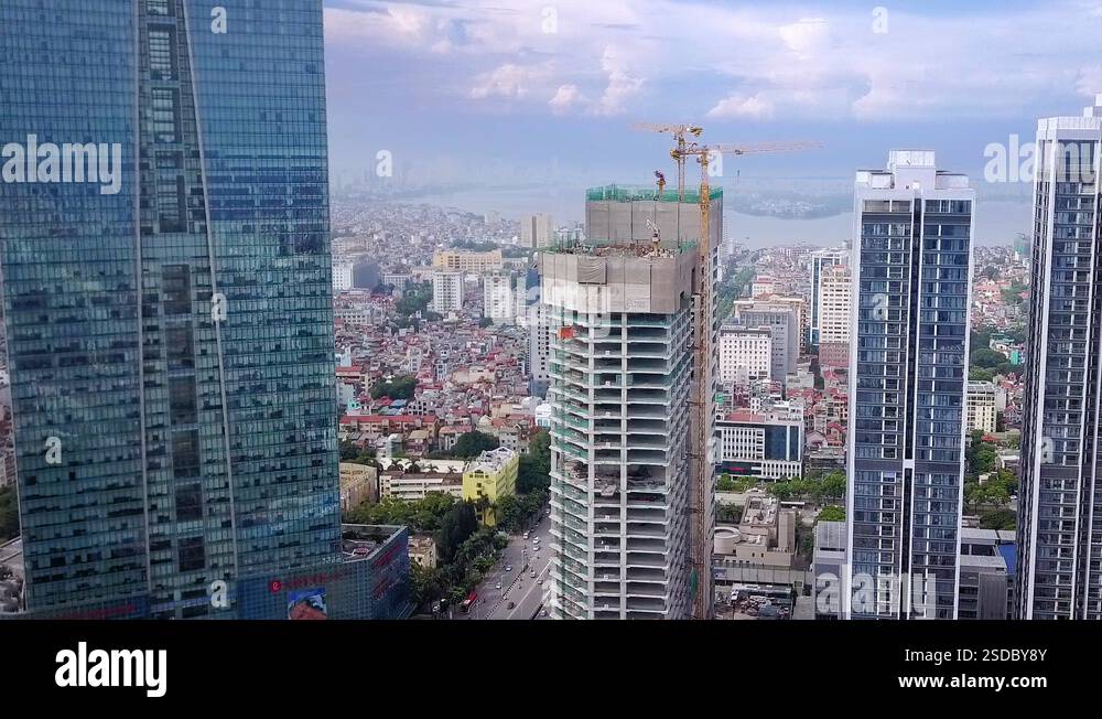 Aerial circle pan around office tower building under construction in ...