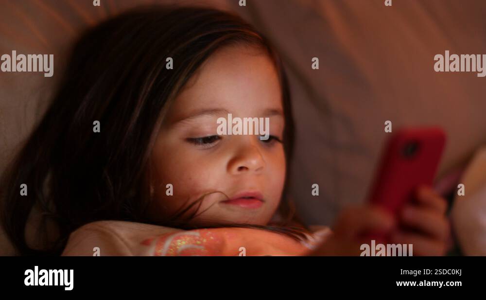 Little girl child using smartphone device, kid playing with cellphone ...