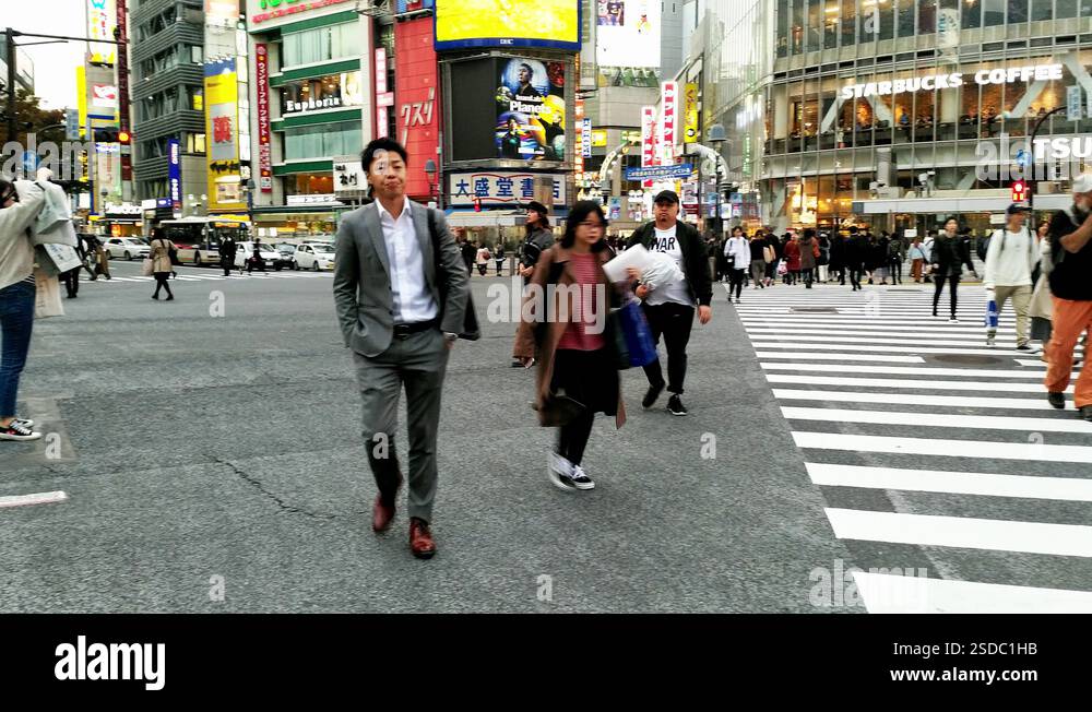 Panning view revealing Japanese businessman and pedestrian trying to ... Panning view revealing Japanese businessman and pedestrian trying to ...